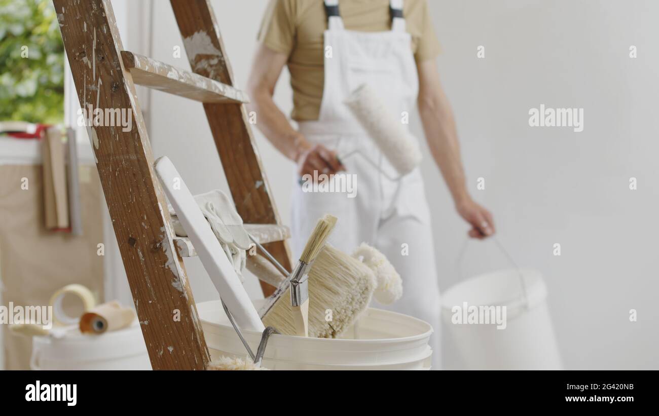 hands of house painter man decorator work of home to renovate, using ...