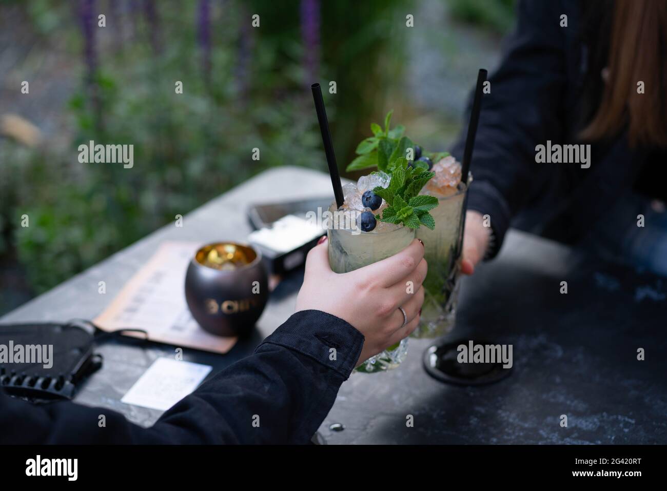 Girls having good time,cheering and drinking cold drinks, enjoying ...