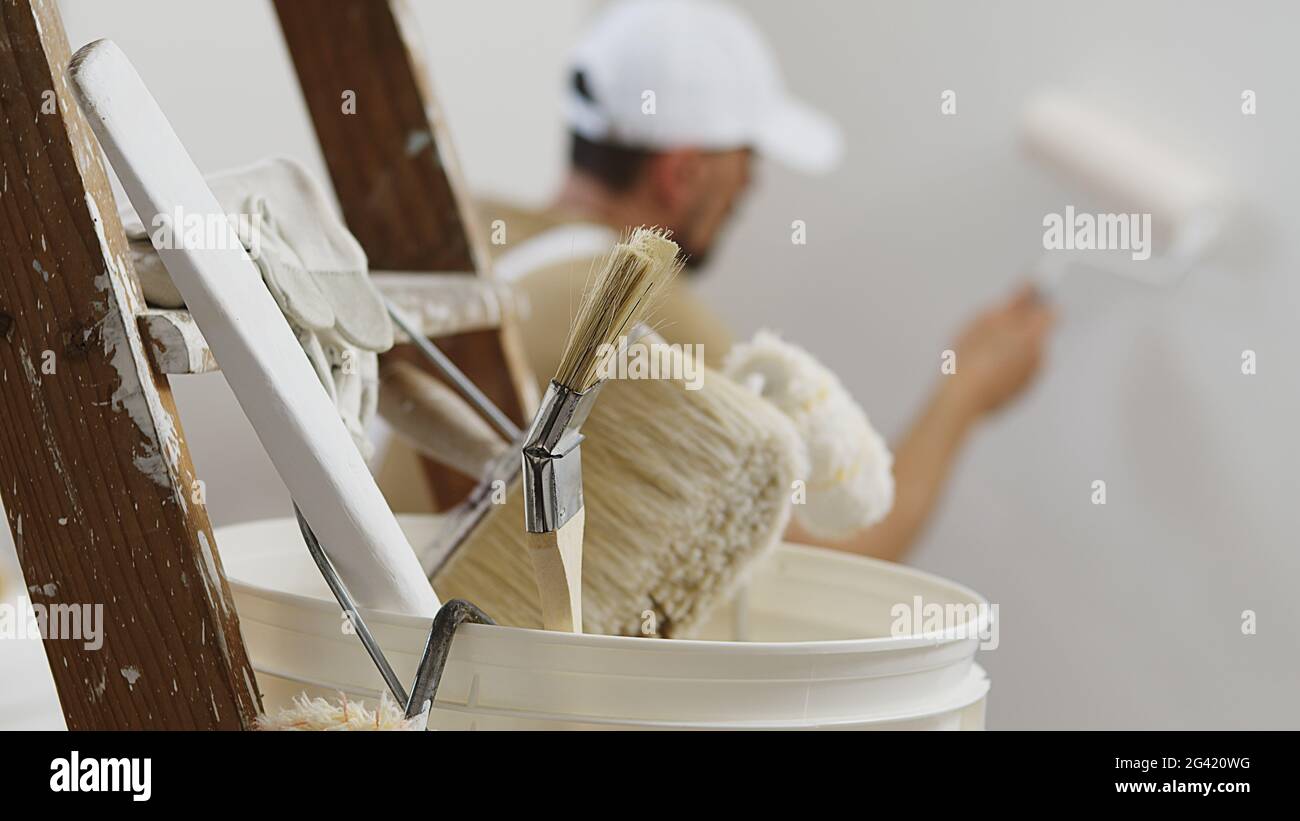 hands of house painter man decorator work of home to renovate, using ...