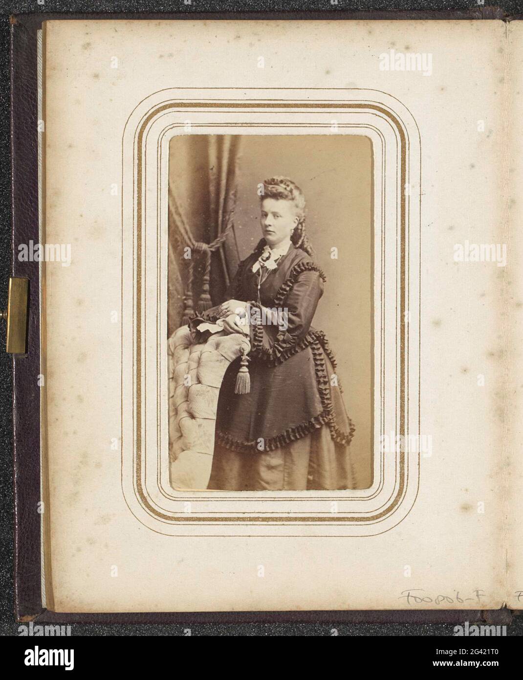 Portrait of a standing woman in a dress. Part of photo album with 36 ...