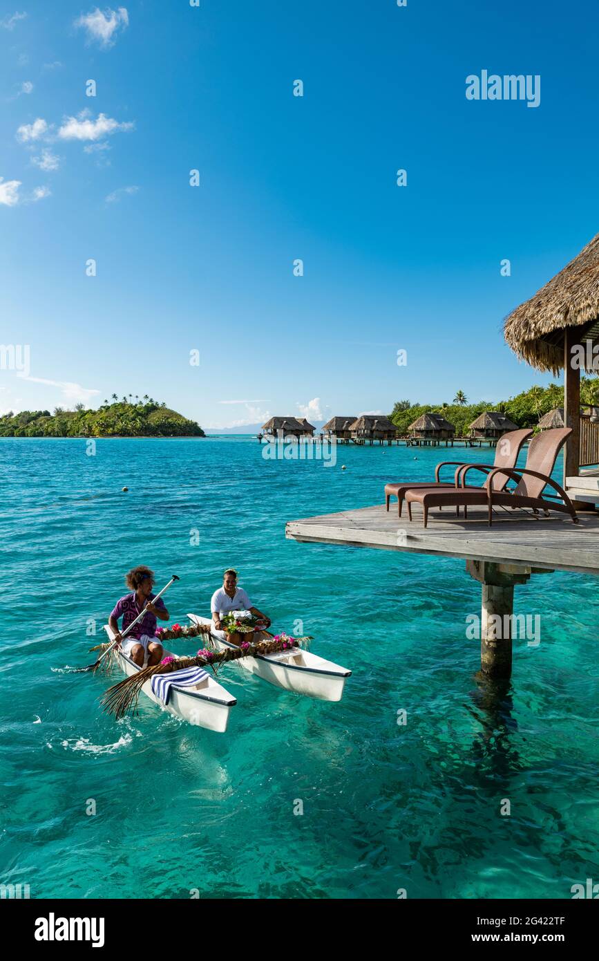 Breakfast is brought in a pirogue outrigger canoe to an overwater ...