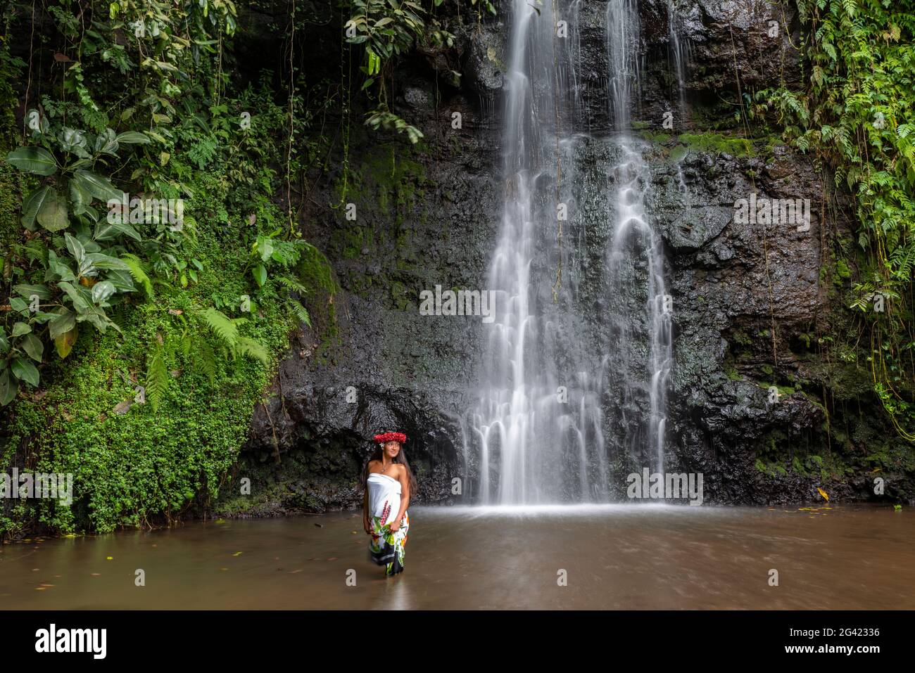 Beautiful young Tahitian woman in front of waterfall in 'The Water ...