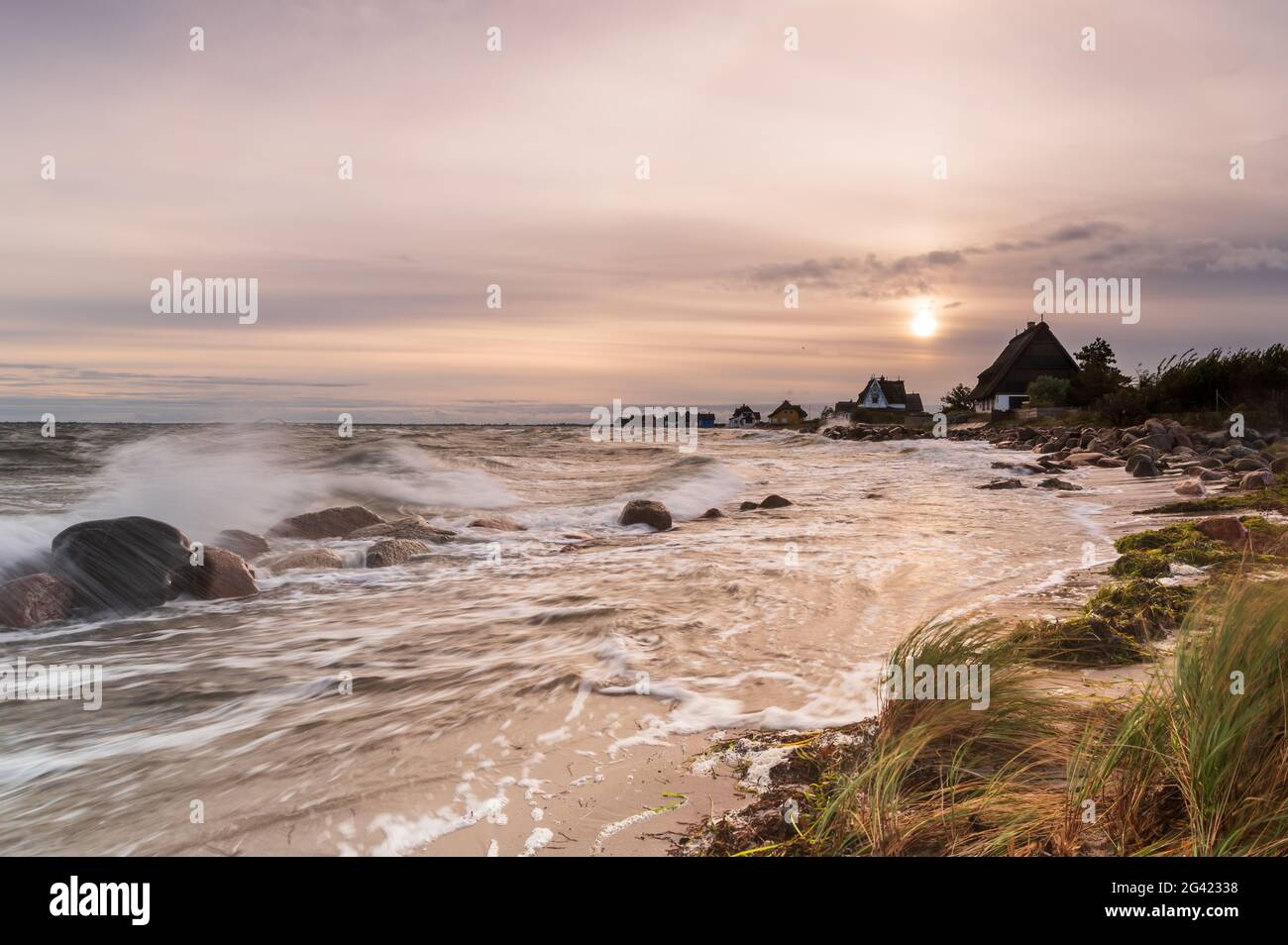 Wind, waves and dunes with a view of the houses of the Graswarder ...