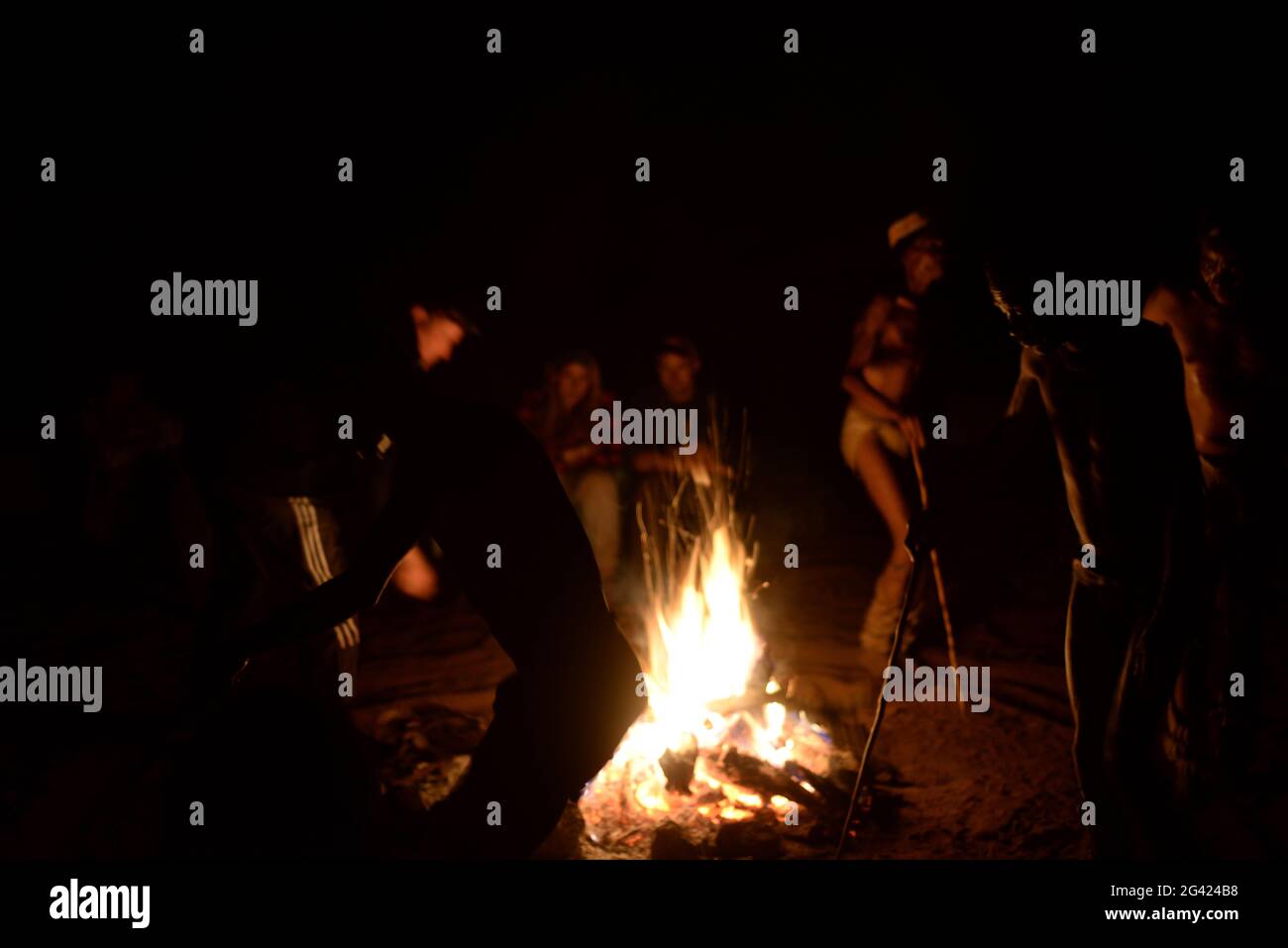 Bushmen Naro Tribe enjoying their traditional dance around a fire at ...