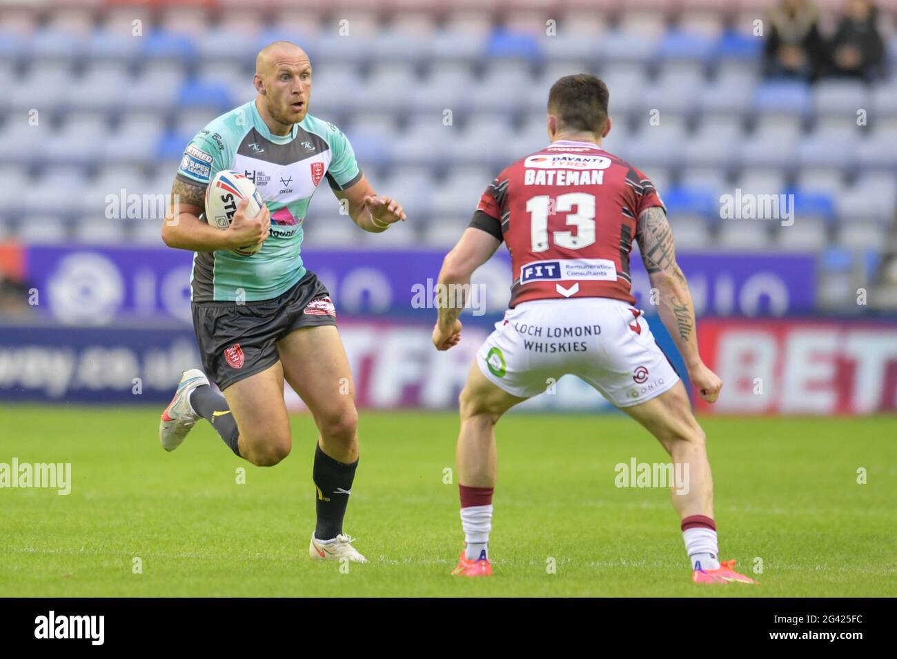 Dean Hadley (13) of Hull KR looks for a way past John Bateman (13) of ...