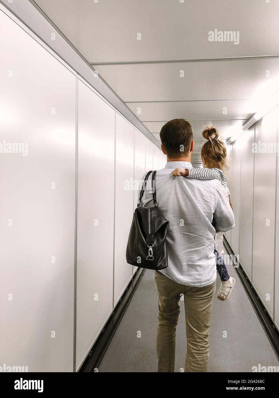Man with child on boarding bridge Stock Photo - Alamy