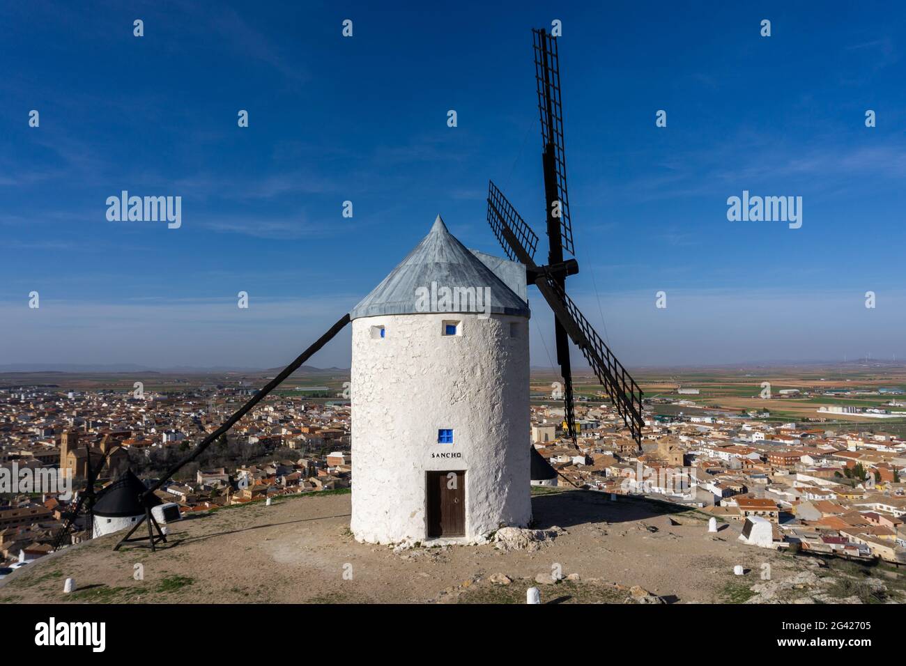 Traditional whitewashed Spanish windmills in La Mancha on a hilltop ...