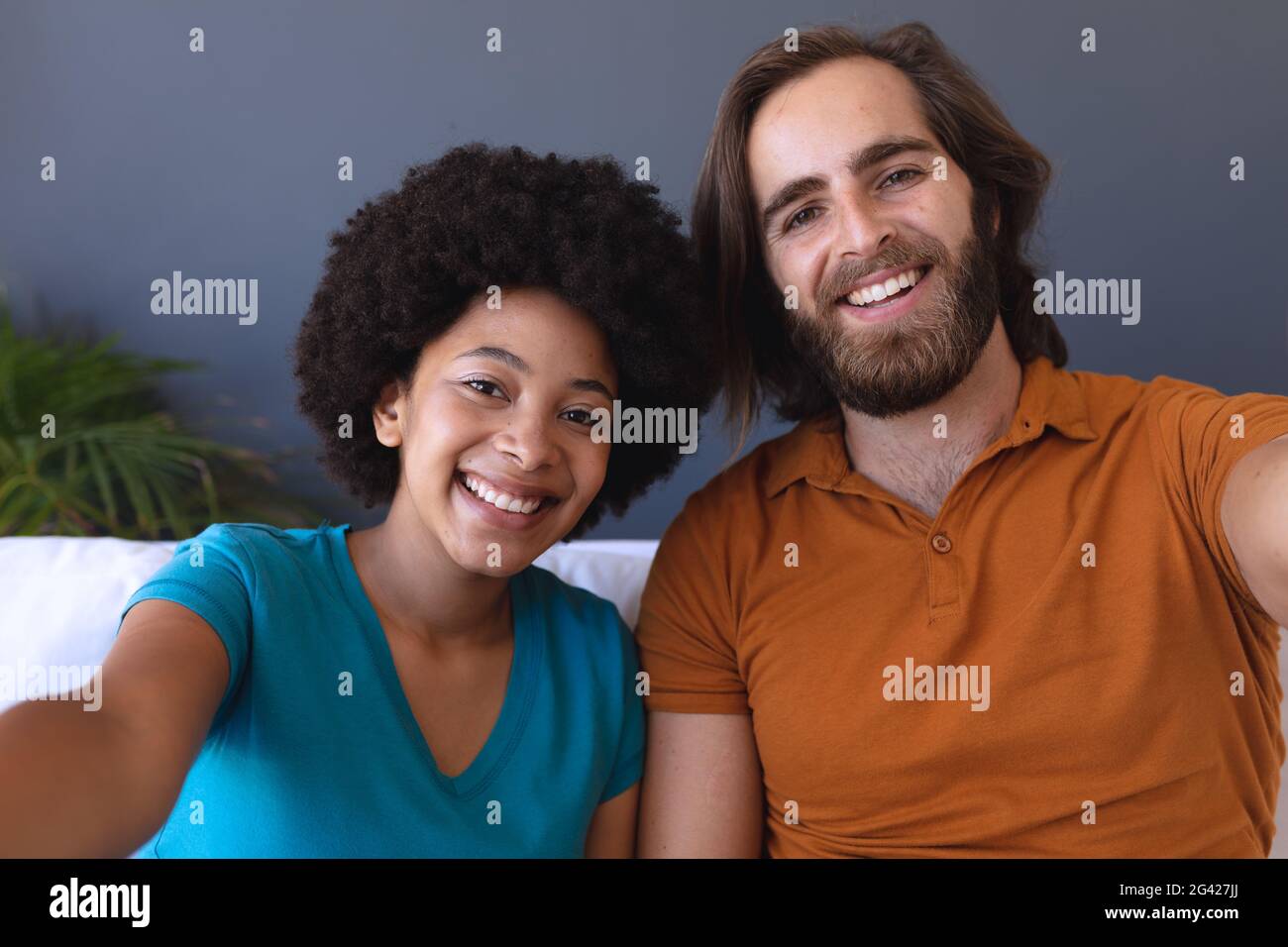 Portrait happy diverse couple sitting hi-res stock photography and ...