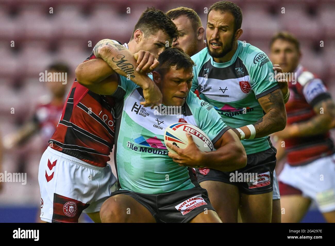 Ryan Hall (5) of Hull KR is tackled by John Bateman (13) of Wigan ...
