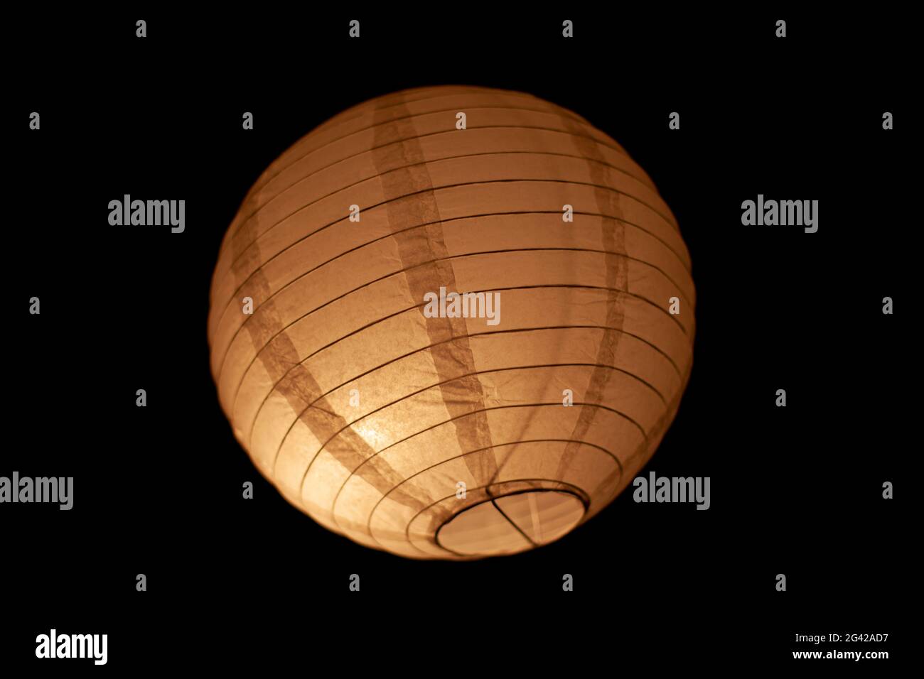 Chinese lamp on a black background. The lamp is in the traditional ...