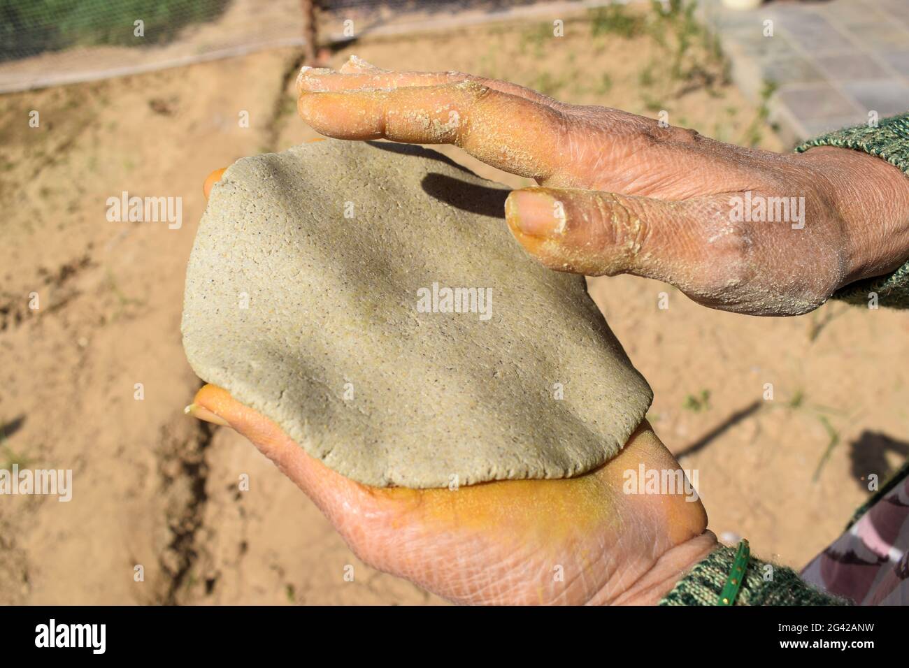 Woman making Indian or Pakistani flatbread made of pearl millet known ...