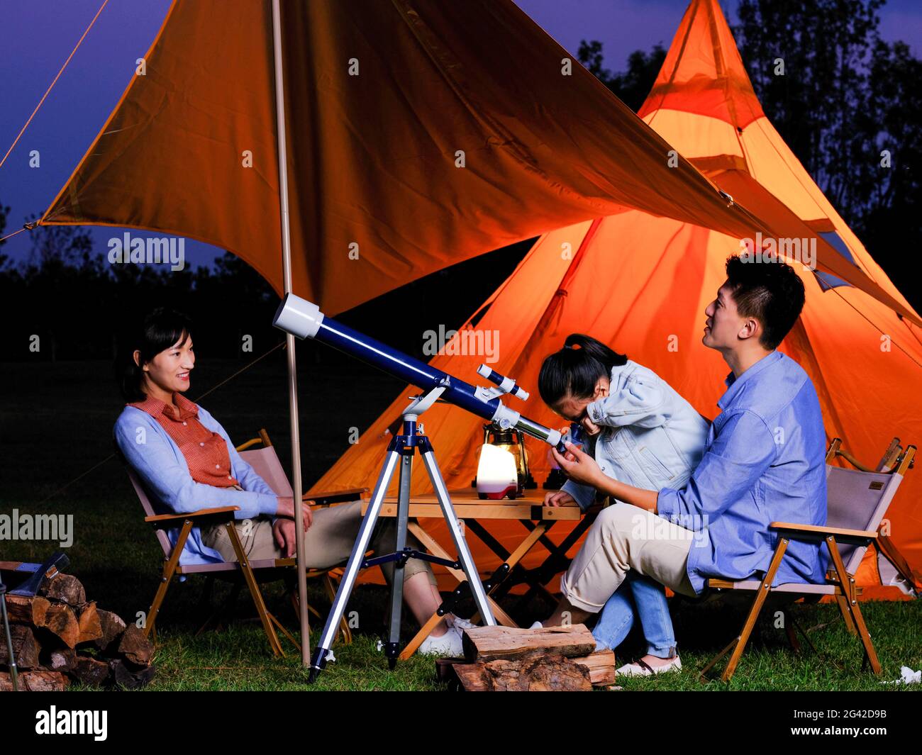 A happy family of three using telescopes outdoors high quality photo ...