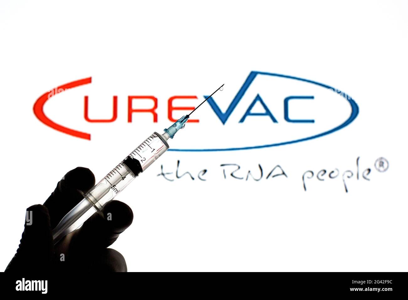 In this photo illustration a hand holding a medical syringe seen in ...