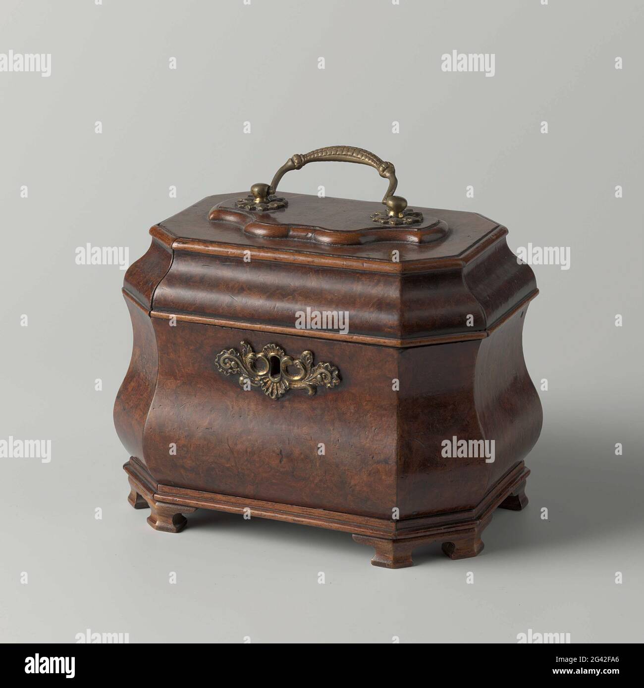 Coffin, glued with carrot nut wood. Octagonal, with curved walls ...