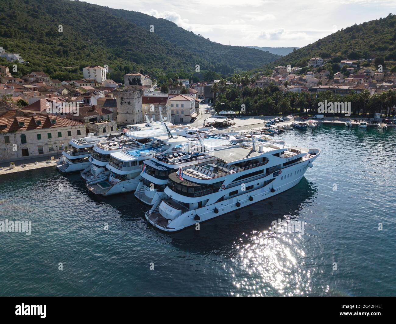 Aerial view of cruise ships and excursion boats docked next to old town ...