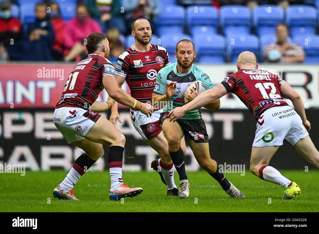 Adam Quinlan (1) of Hull KR is tackled by Liam Farrell (12) of Wigan ...
