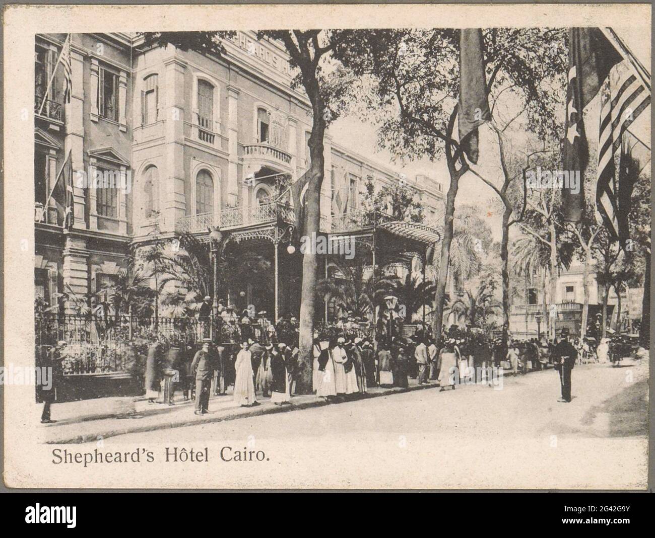 Street face in Cairo with waiting people for the Shepheards Hotel ...