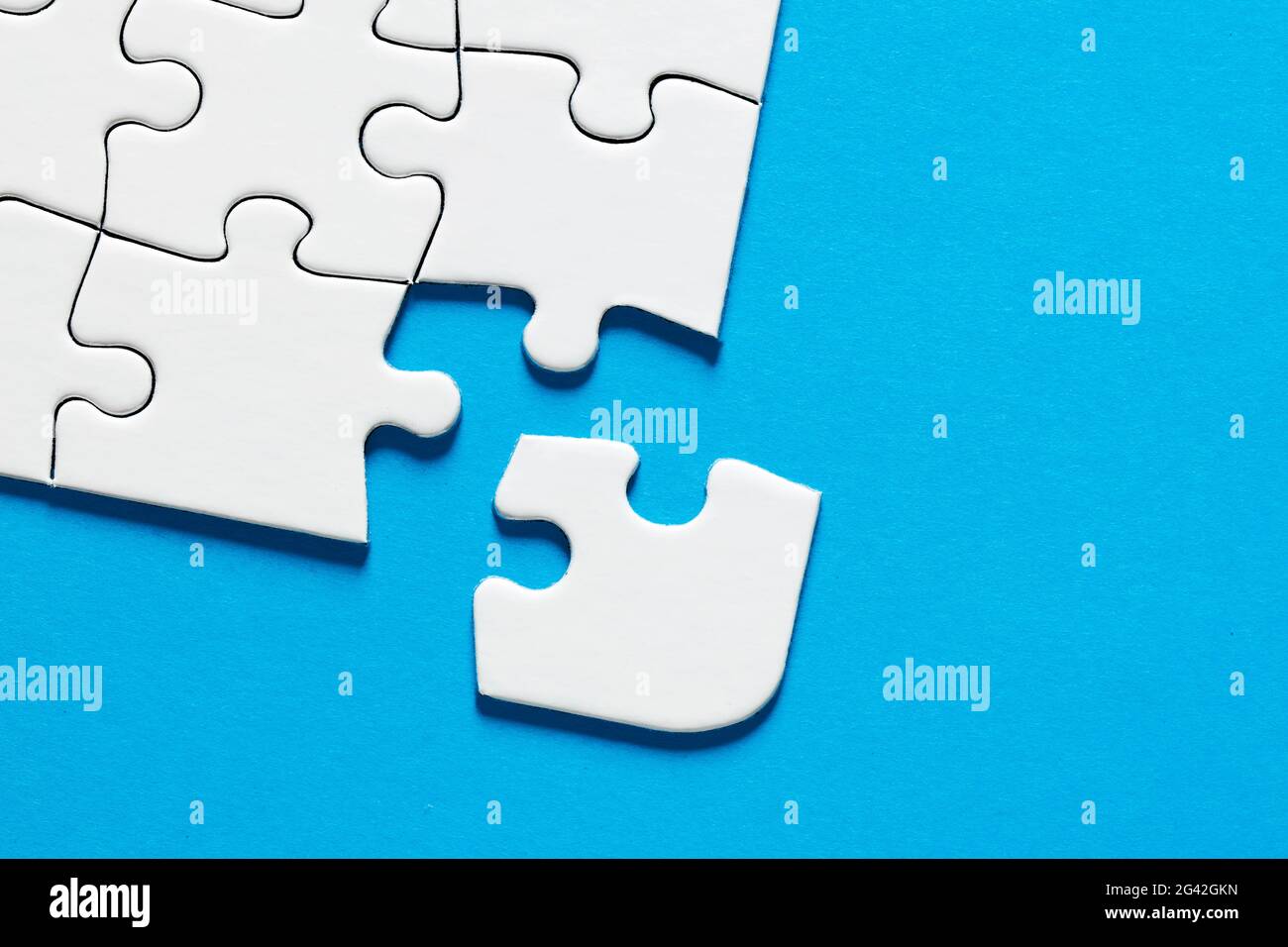 One missing puzzle piece with blue background with copy space ...