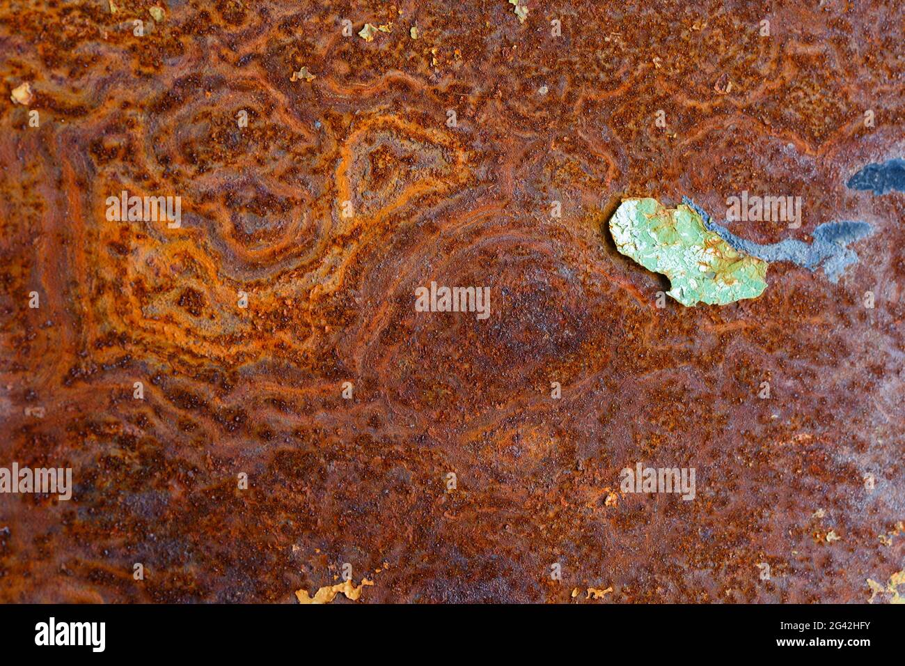 artisticly rusted flat iron surface with leftowers of peeled off paint ...