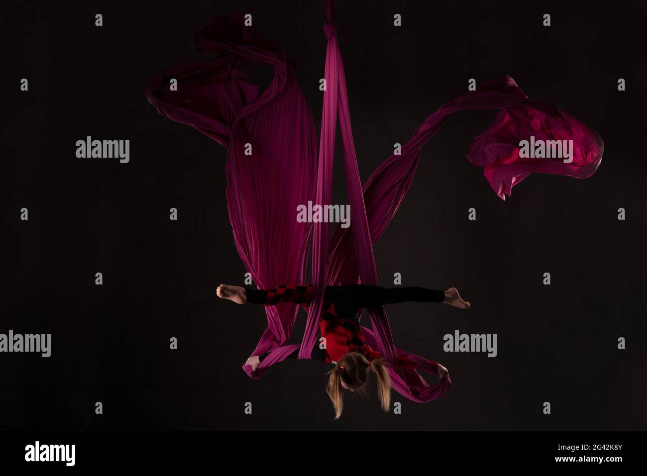 Teen dancer performing acrobatic dance on aerial silks Stock Photo - Alamy