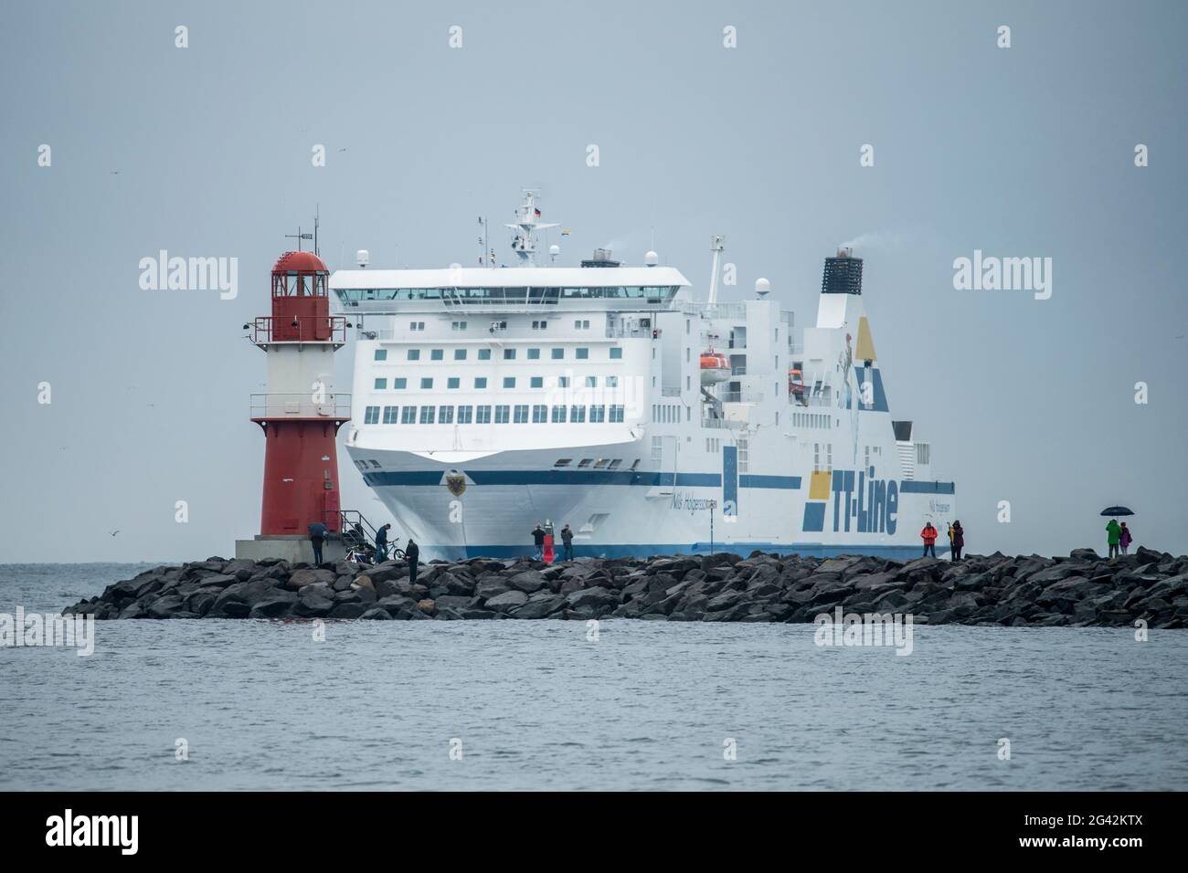 Cruise ship in front of lighthouse at the port of Rostock, Germany ...