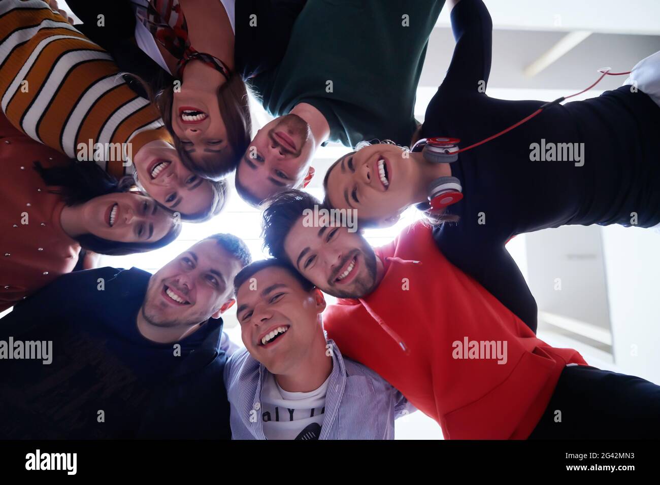 Group of happy young people showing their unity Stock Photo - Alamy