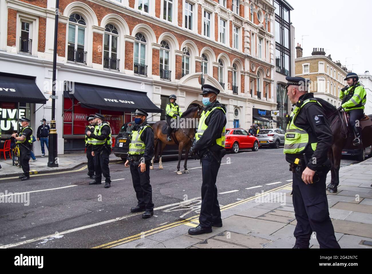 Police officers form a cordon in Covent Garden to separate England and ...