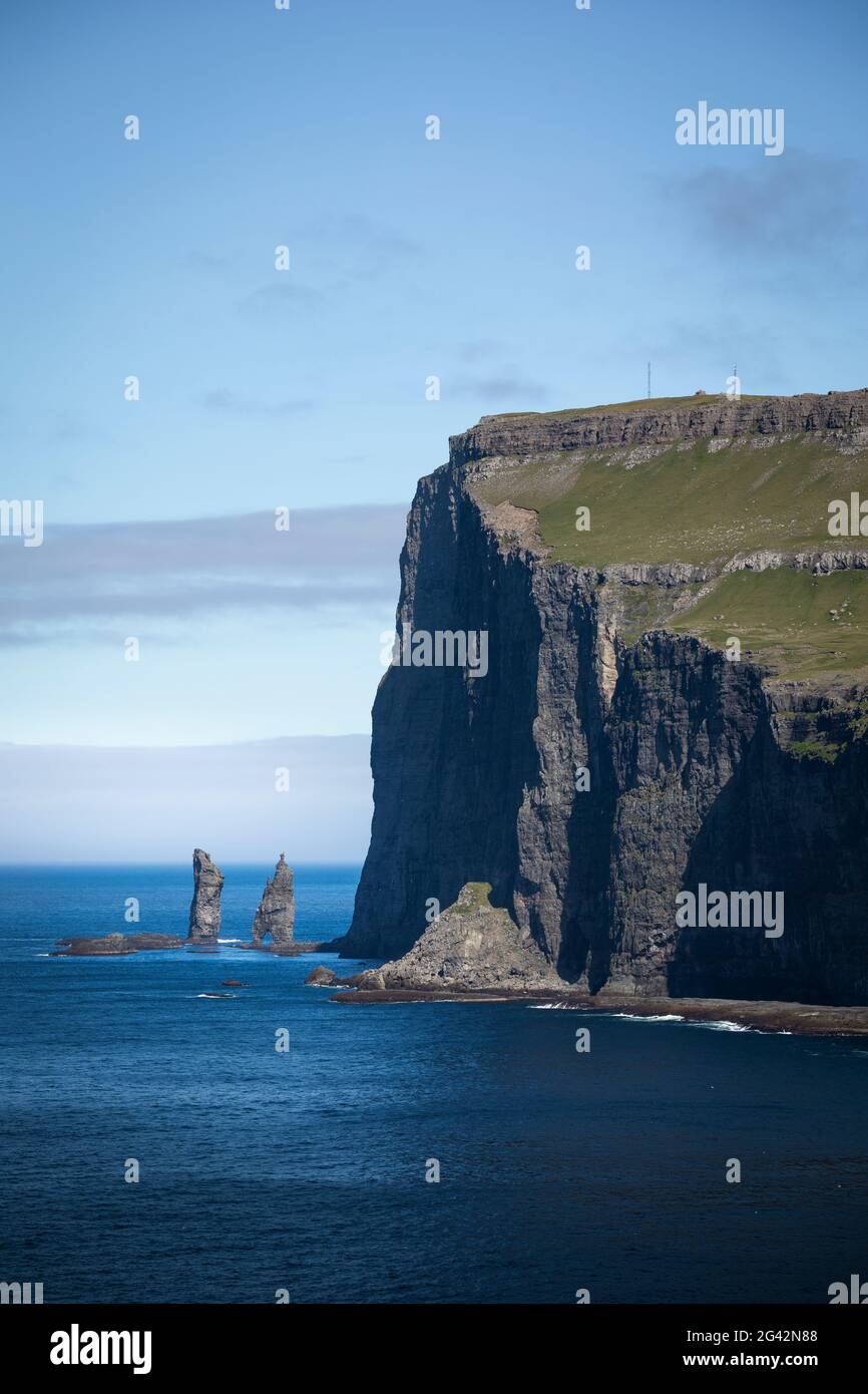 Risin og Kellingin rocks on Faroe Islands during the day with sun and ...