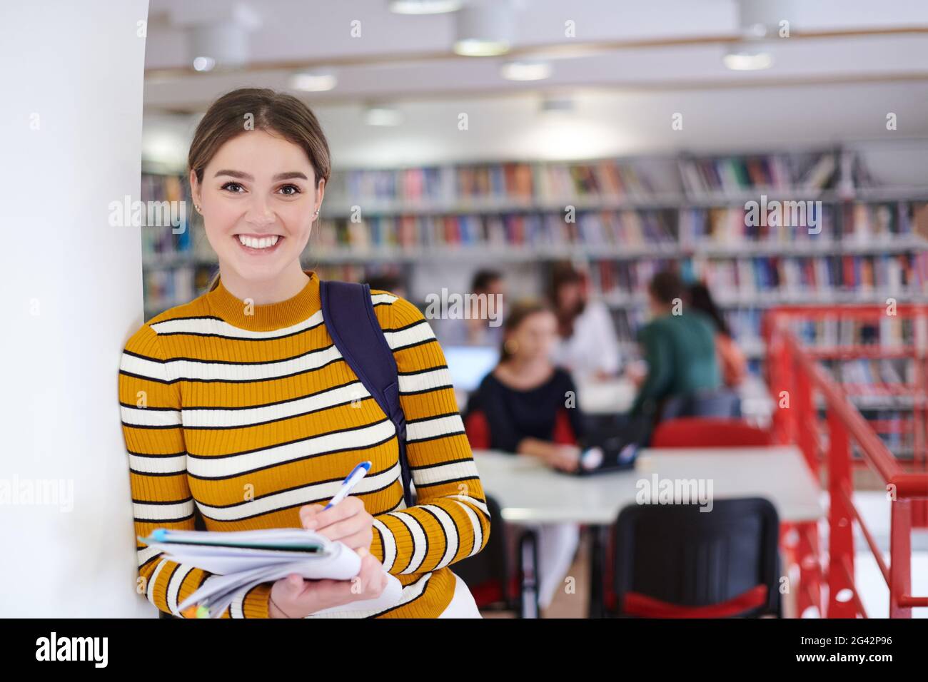 The student uses a notebook and a school library Stock Photo - Alamy