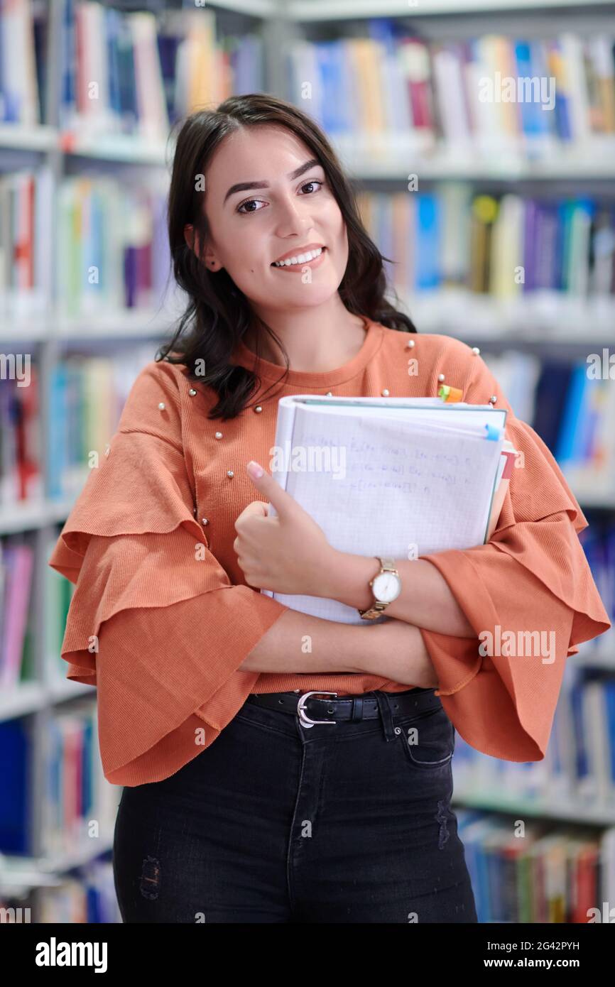 The student uses a notebook and a school library Stock Photo - Alamy
