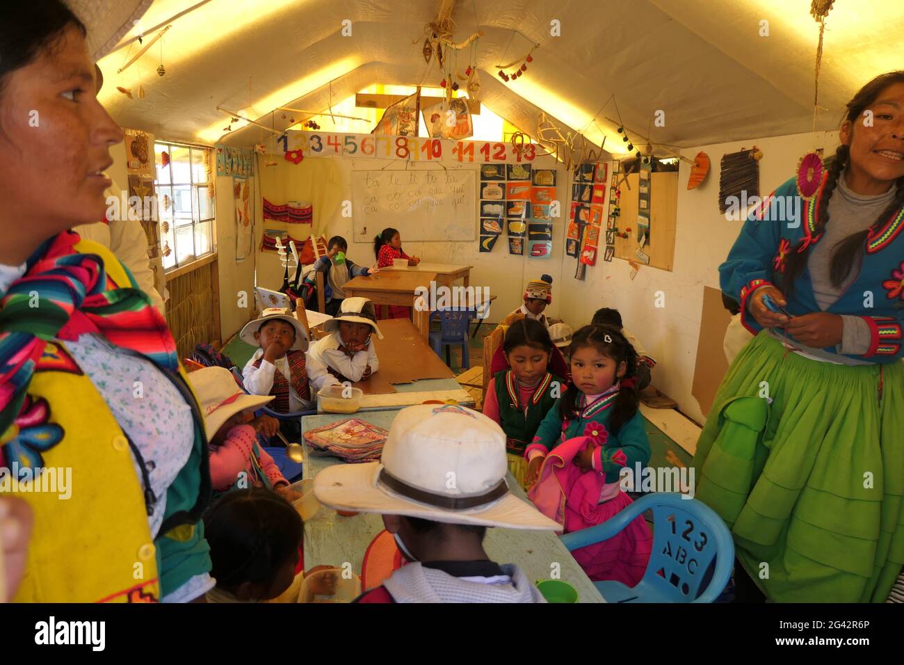 Children and teachers in traditional Andean clothing participate in ...