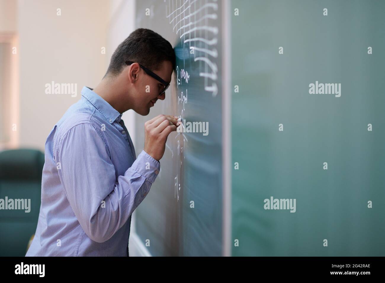 The student does the task on the board Stock Photo - Alamy