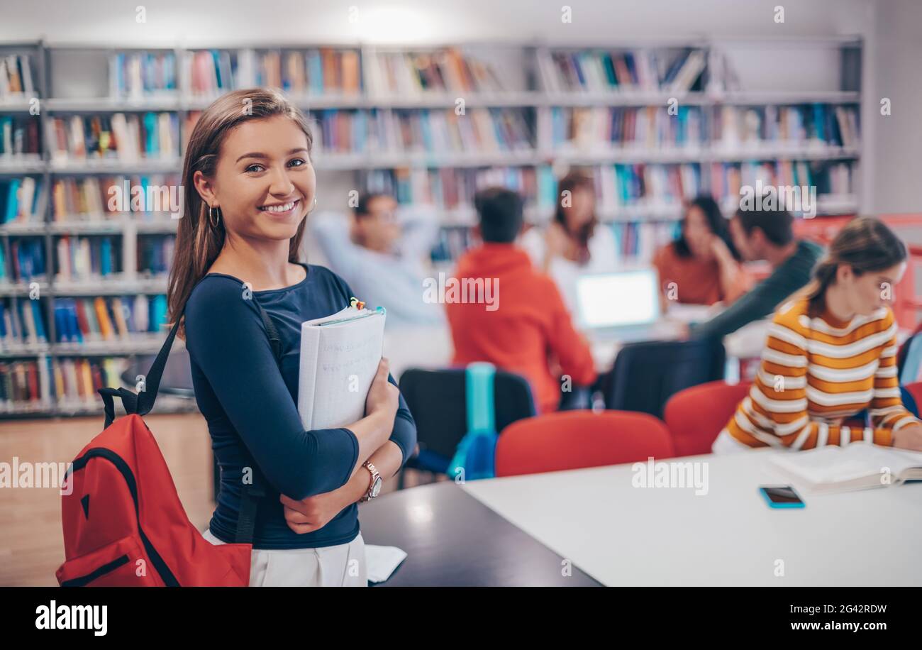 The student uses a notebook and a school library Stock Photo - Alamy