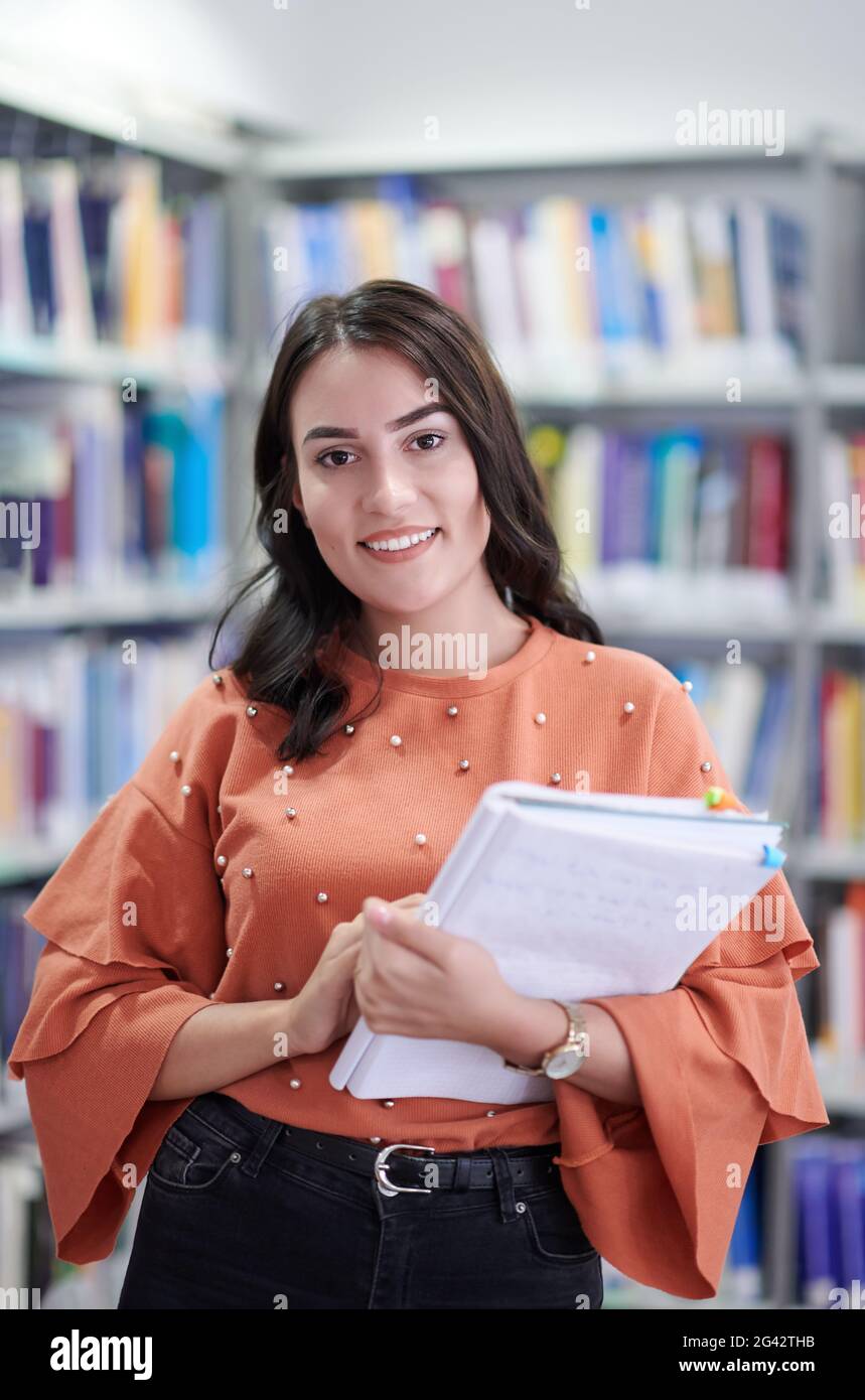 The student uses a notebook and a school library Stock Photo - Alamy
