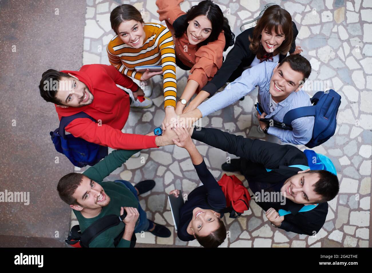 Group of happy young people showing their unity Stock Photo - Alamy