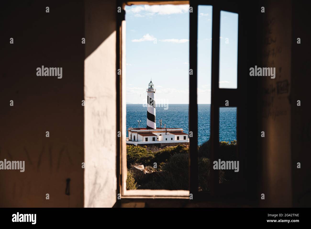 Lighthouse from the window in Mallorca Stock Photo - Alamy