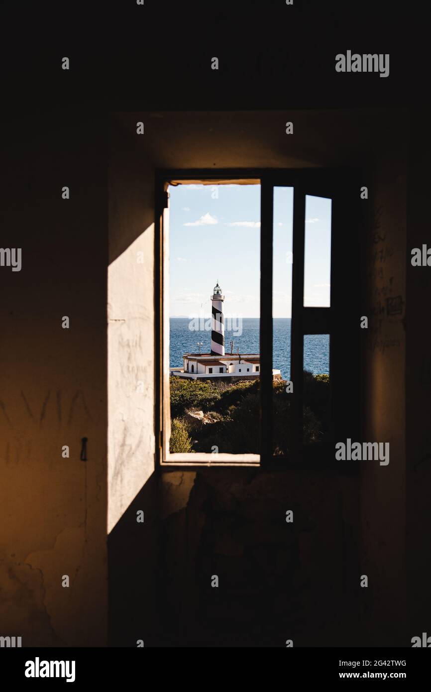Lighthouse from the window in Mallorca Stock Photo - Alamy
