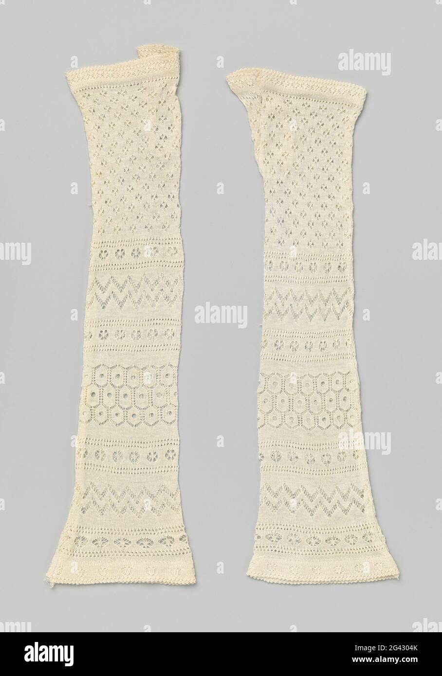 Mitaine from white ajour knitwear, with cut thumbs. Left mitaine of ...