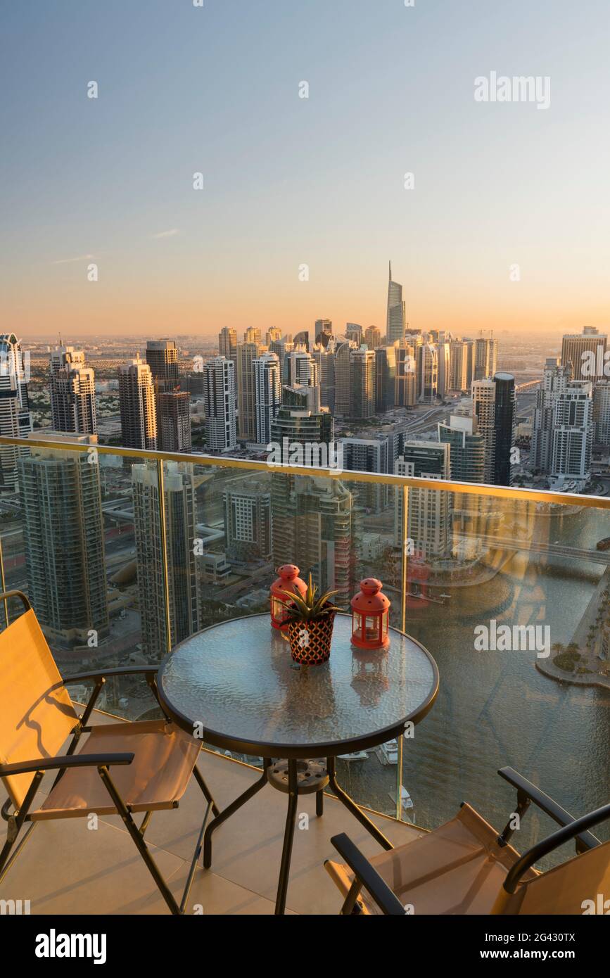 View from an apartment over the Dubai Marina, table with chairs ...