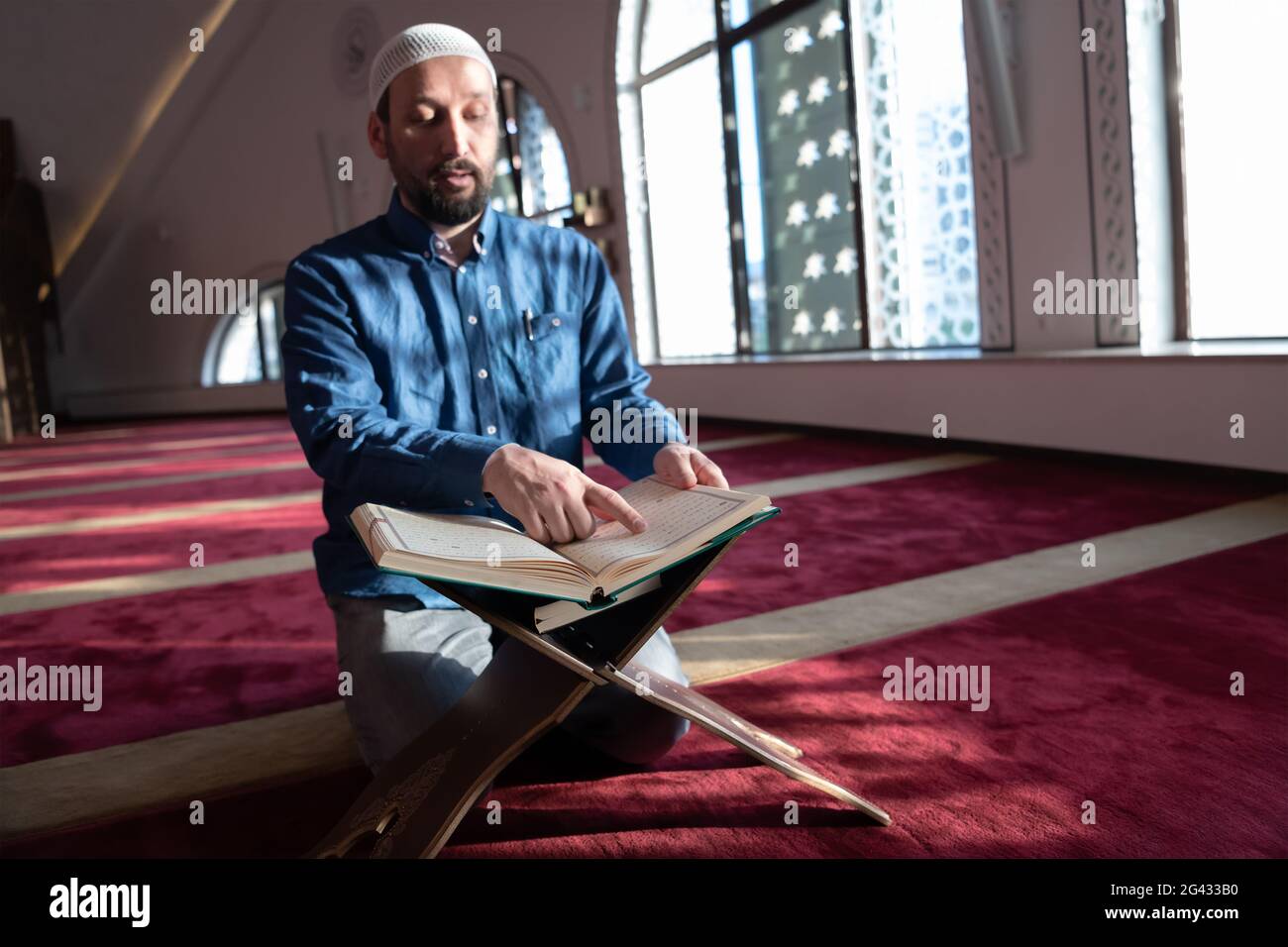 Muslim man praying Allah alone inside the mosque and reading islamic ...