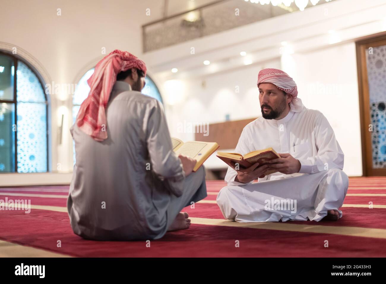 Two muslim people in mosque reading quran together concept of islamic ...