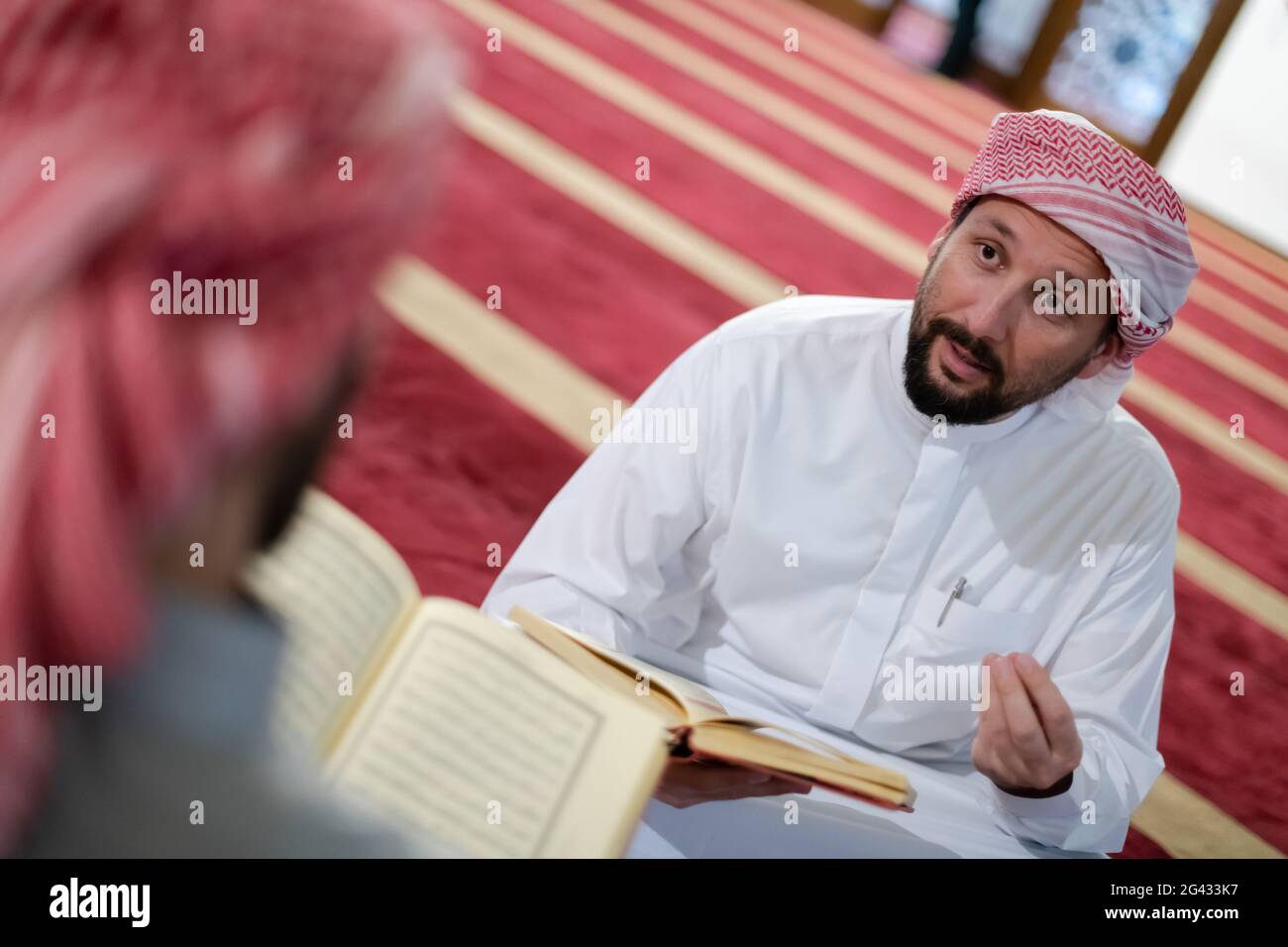 Two muslim people in mosque reading quran together concept of islamic ...