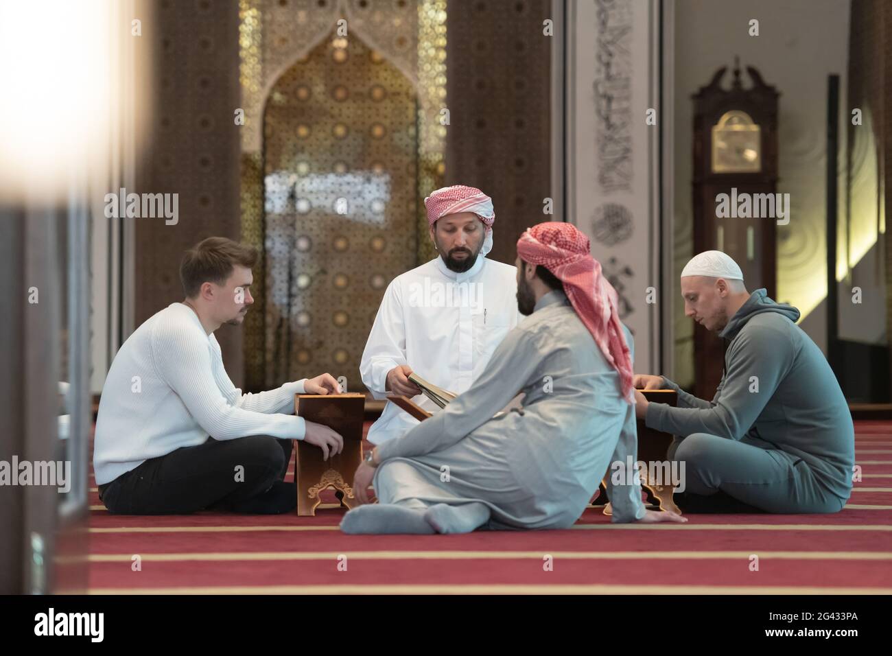 Muslim people in mosque reading quran together Stock Photo - Alamy
