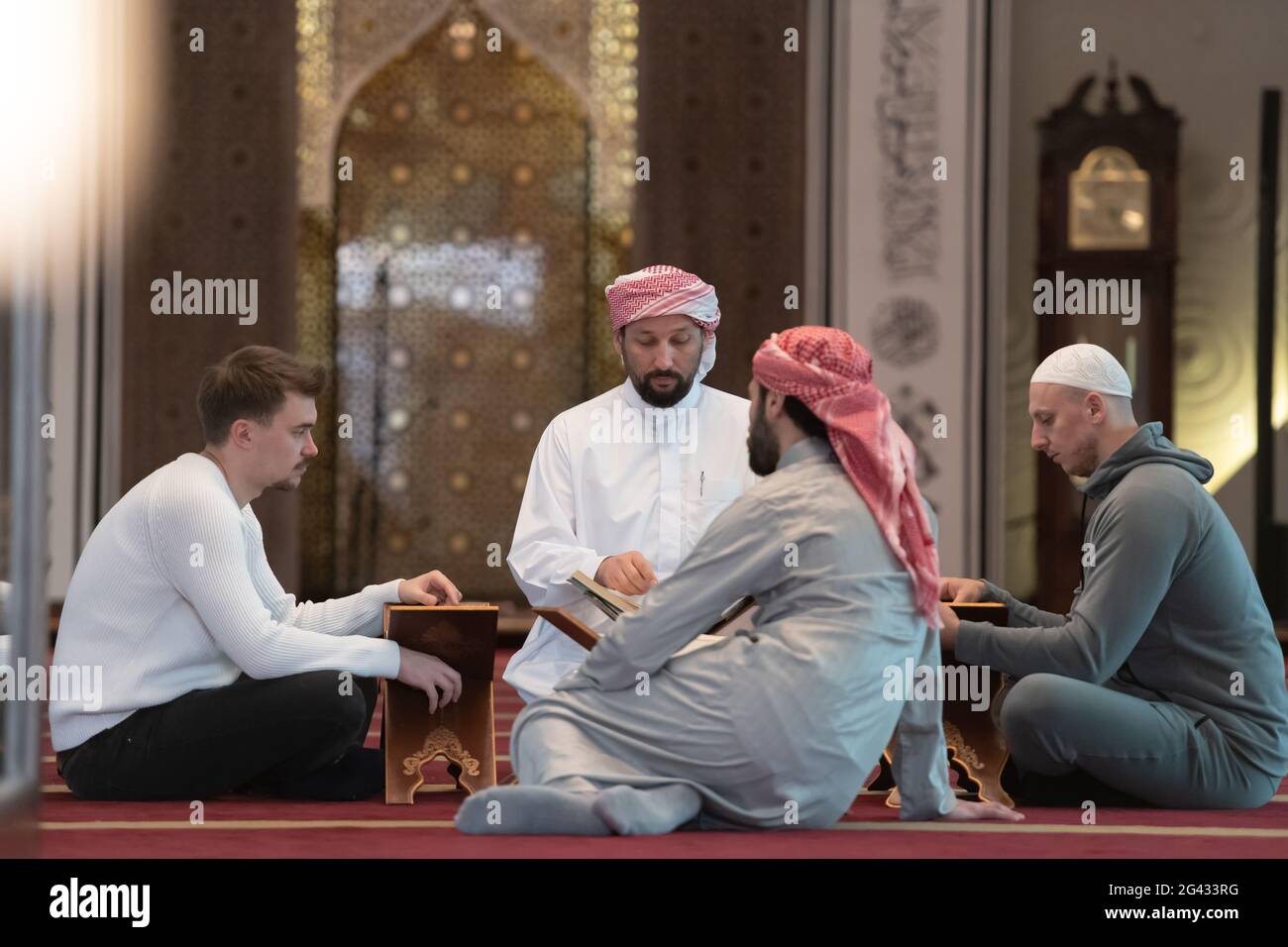 Muslim people in mosque reading quran together Stock Photo - Alamy