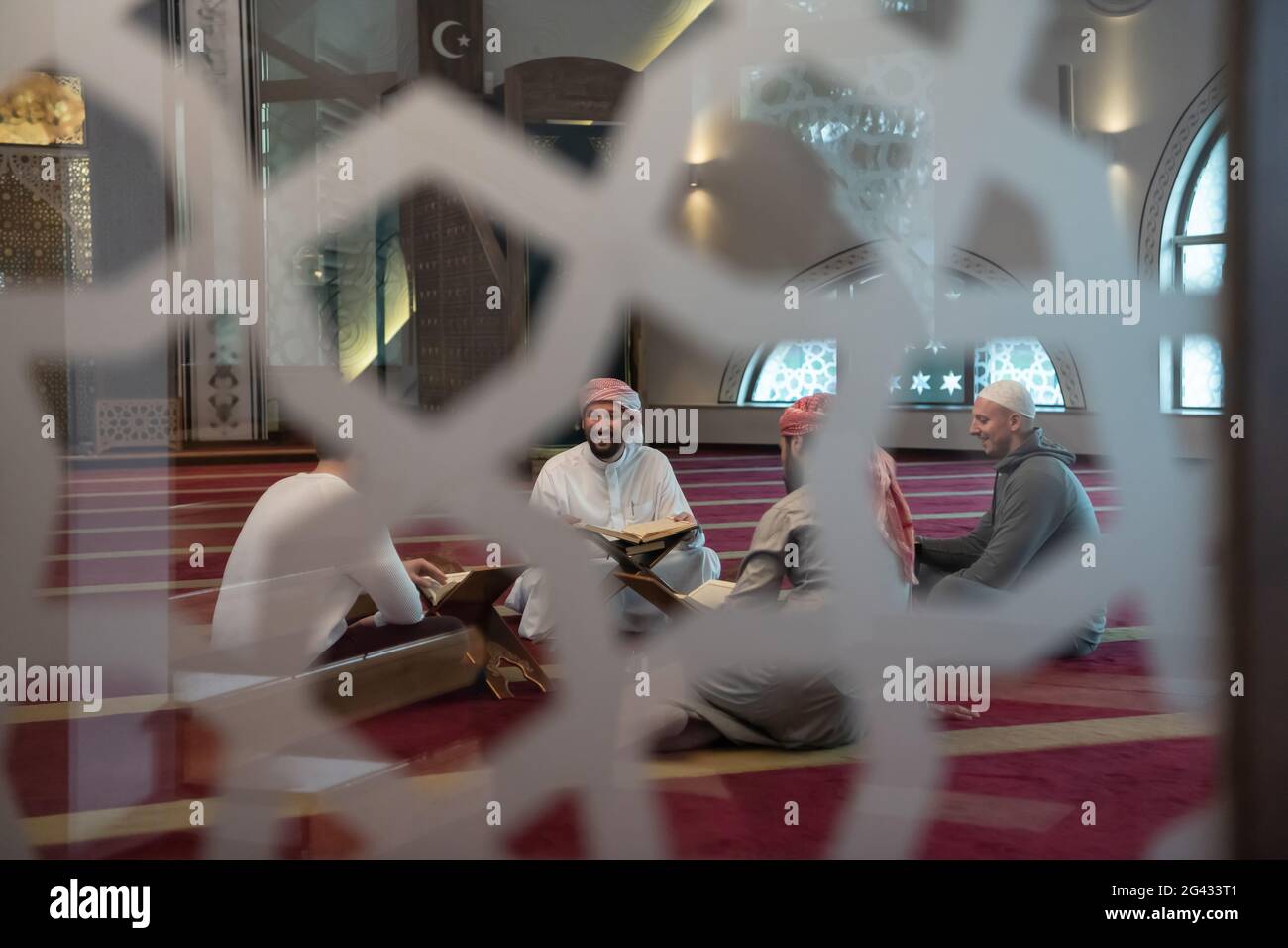 Muslim people in mosque reading quran together Stock Photo - Alamy