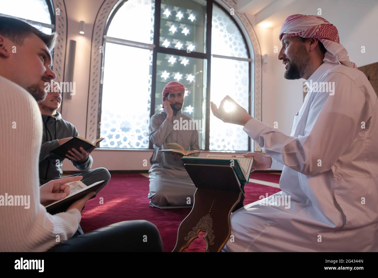 Muslim people in mosque reading quran together Stock Photo - Alamy
