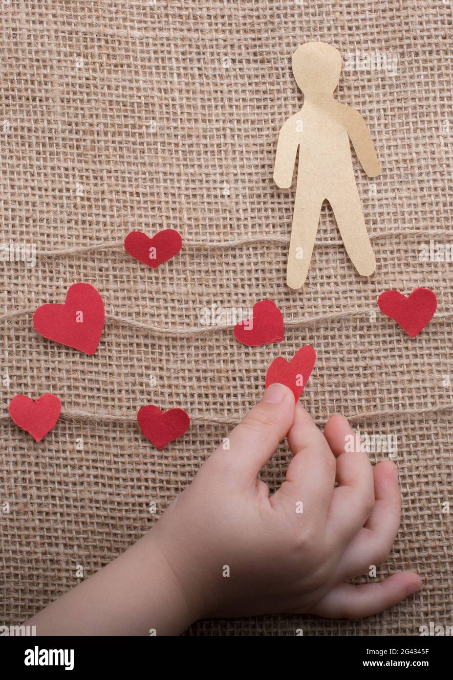 Paper man shape in hand in the view Stock Photo - Alamy