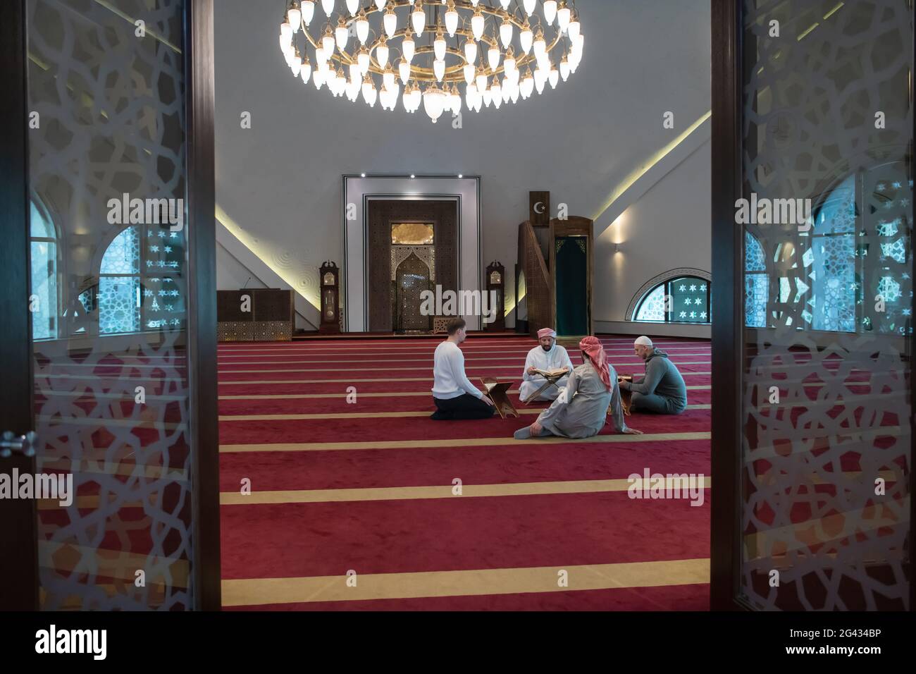 Muslim people in mosque reading quran together Stock Photo - Alamy