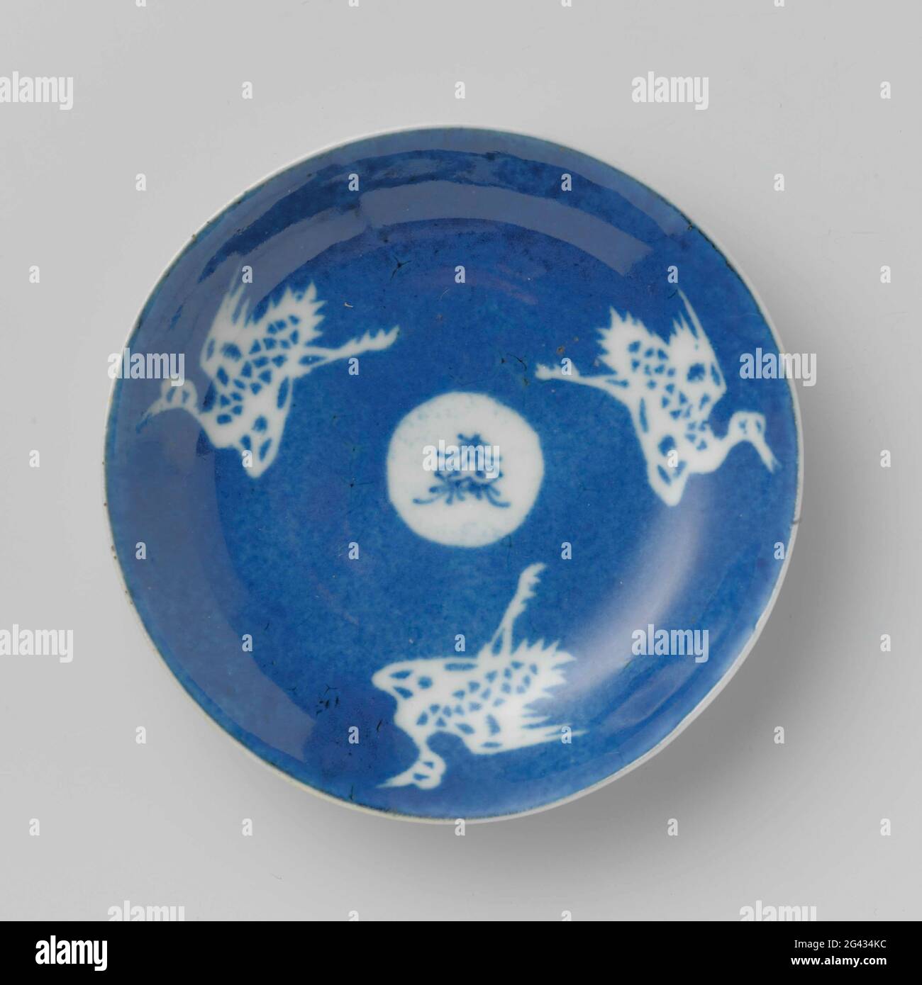 Saucer with powder blue and cranes. Dish of porcelain, painted in ...