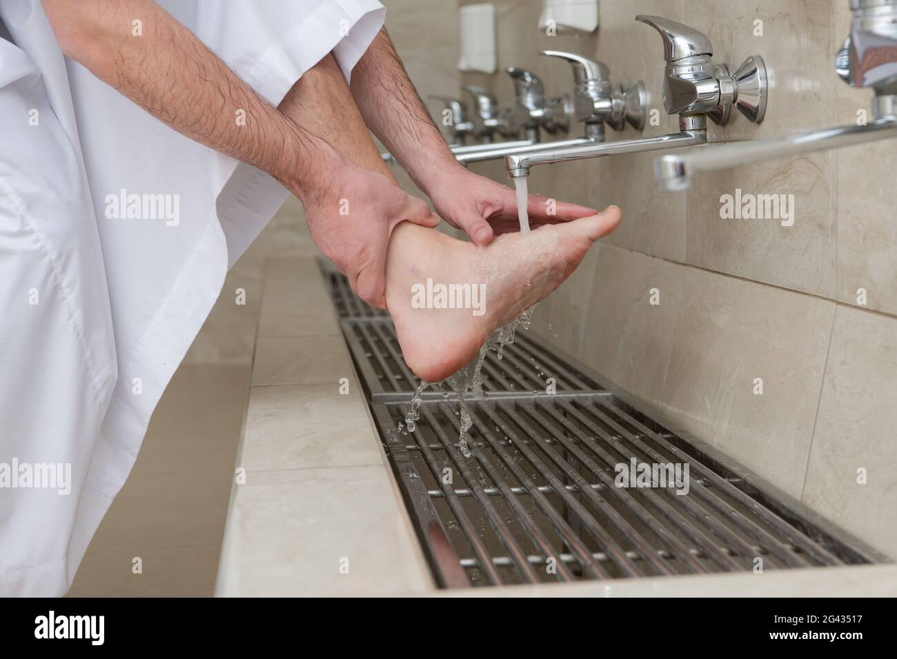 A Muslim takes ablution for prayer. Islamic religious rite Stock Photo ...